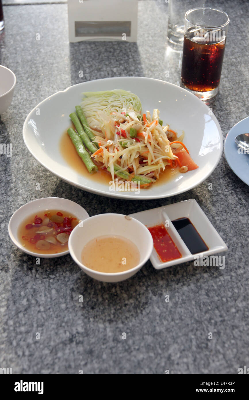 green papaya salad in white dish on the foods table Stock Photo - Alamy