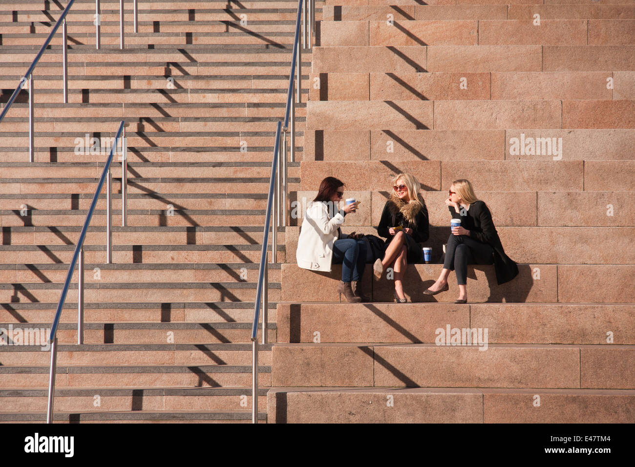 People relaxing in the sunshine on the steps near Liverpool One ...
