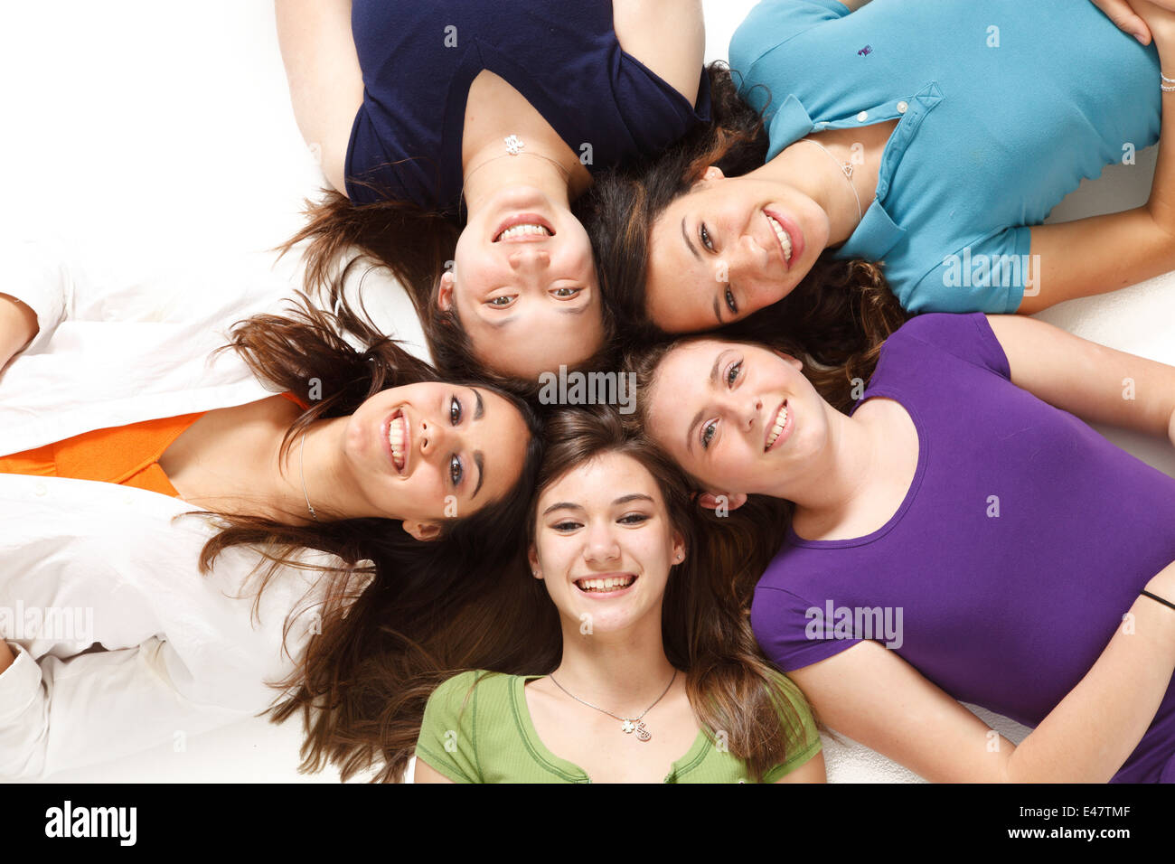 a group of five girls having fun hanging out making a circle on the ...