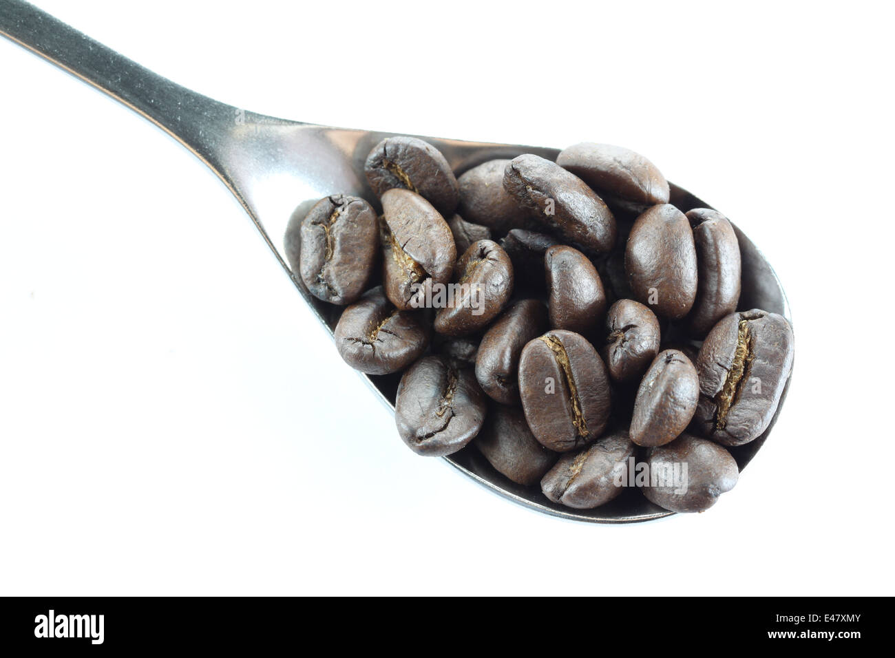 Coffee beans in a stainless steel spoon on white background Stock Photo ...