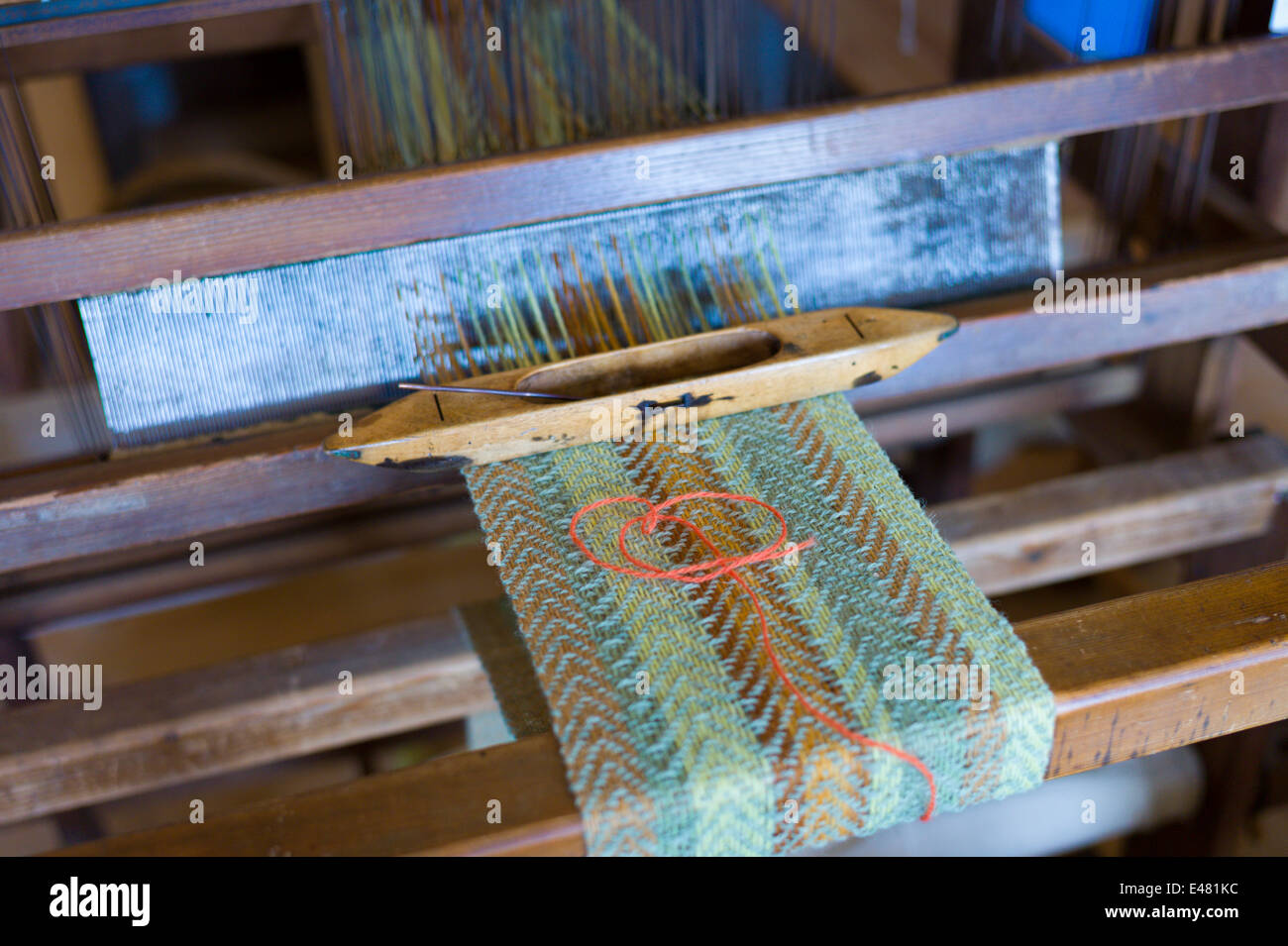 Traditional hand loom with bobbin producing 100% lambswool woolen scarf ...