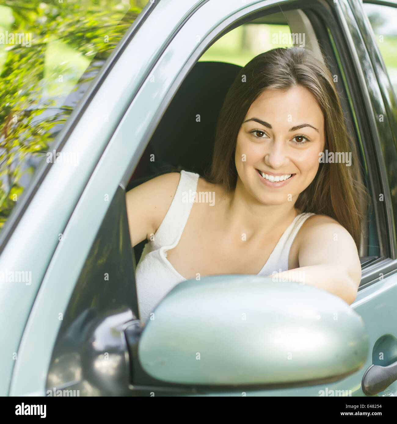 Happy young woman driving a car Stock Photo - Alamy