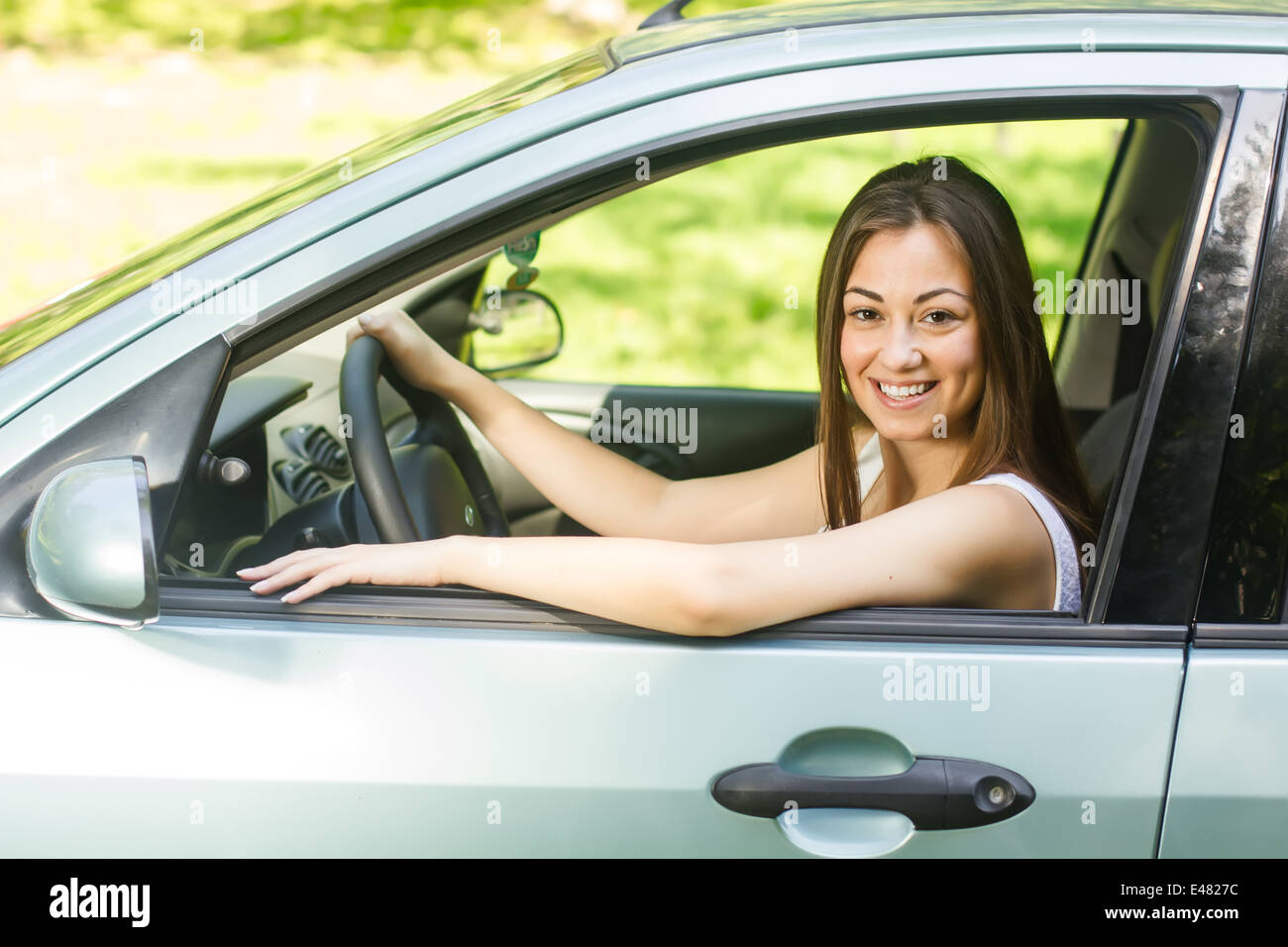Happy young woman driving a car Stock Photo - Alamy