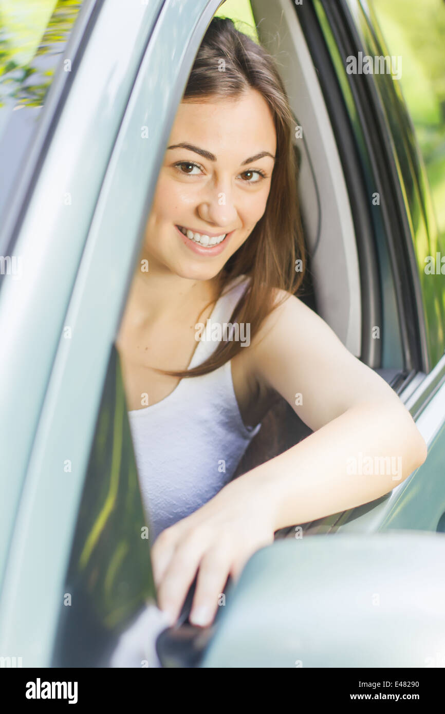 Beautiful young woman driving a car Stock Photo - Alamy