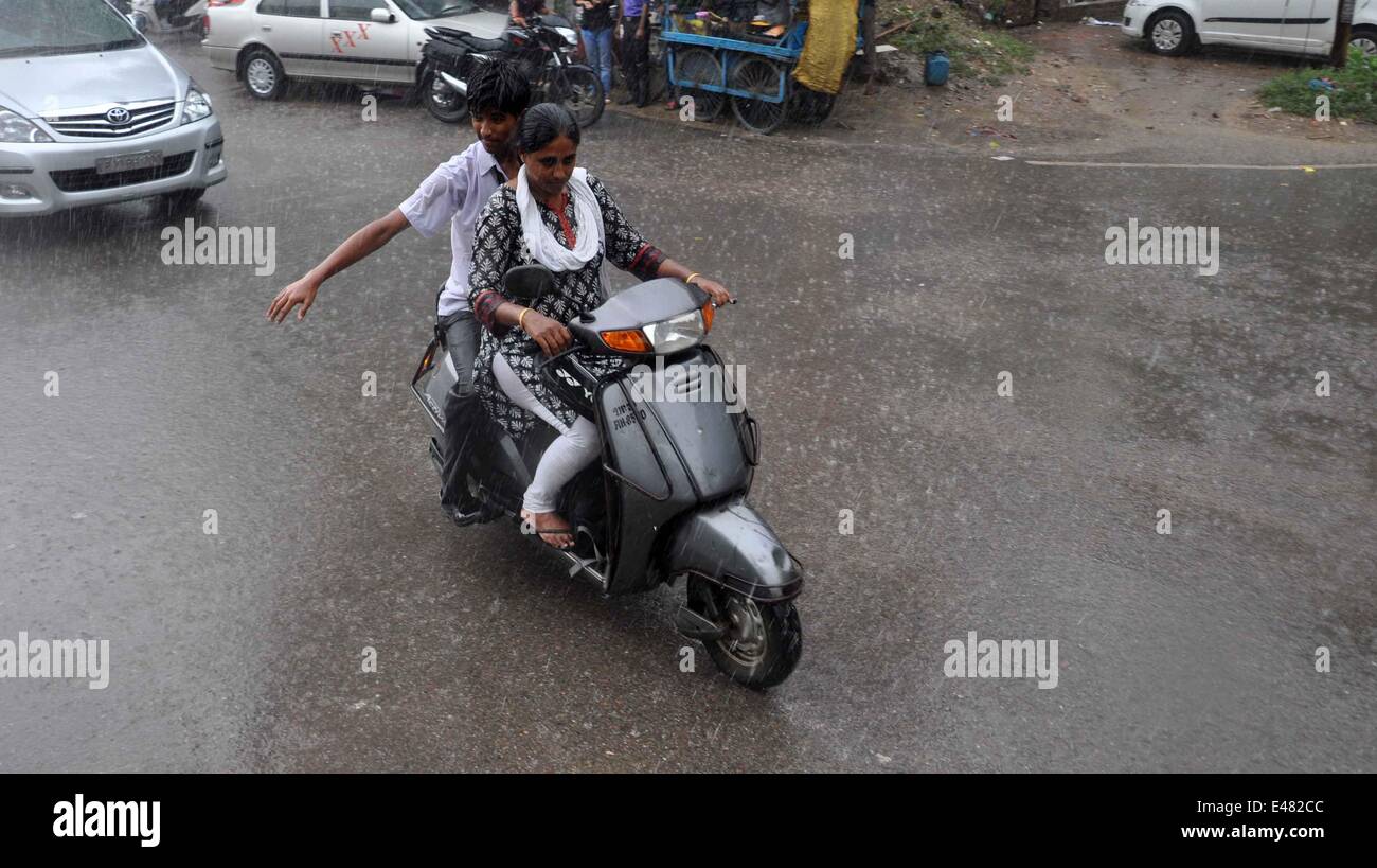 The commuters drive despite of heavy monsoon rain in Allahabad. It is ...