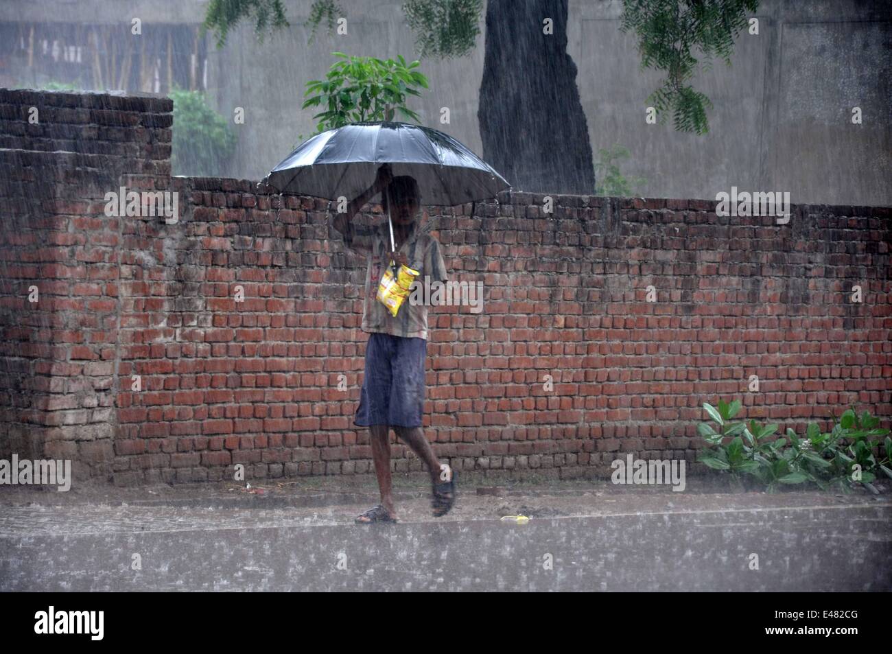 The girl enjoys the rain in Allahabad. It is expected that monsoon rain ...