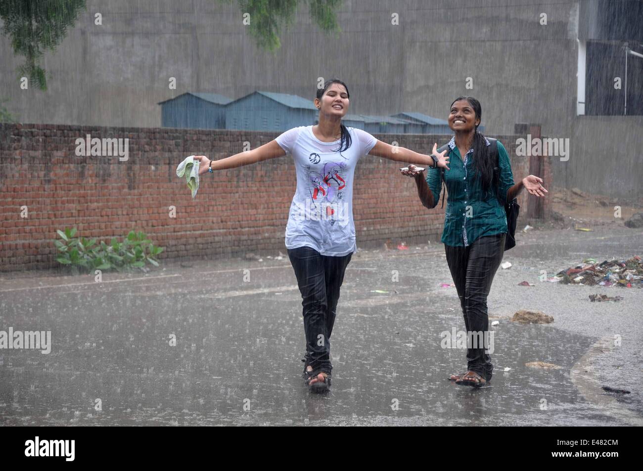 The girls enjoy the rain in Allahabad. It is expected that monsoon rain ...