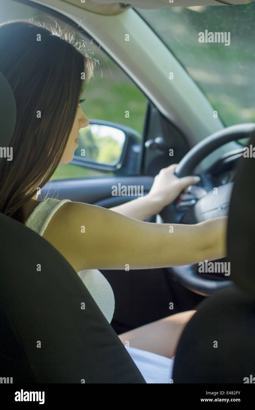 Beautiful young woman driving a car Stock Photo - Alamy