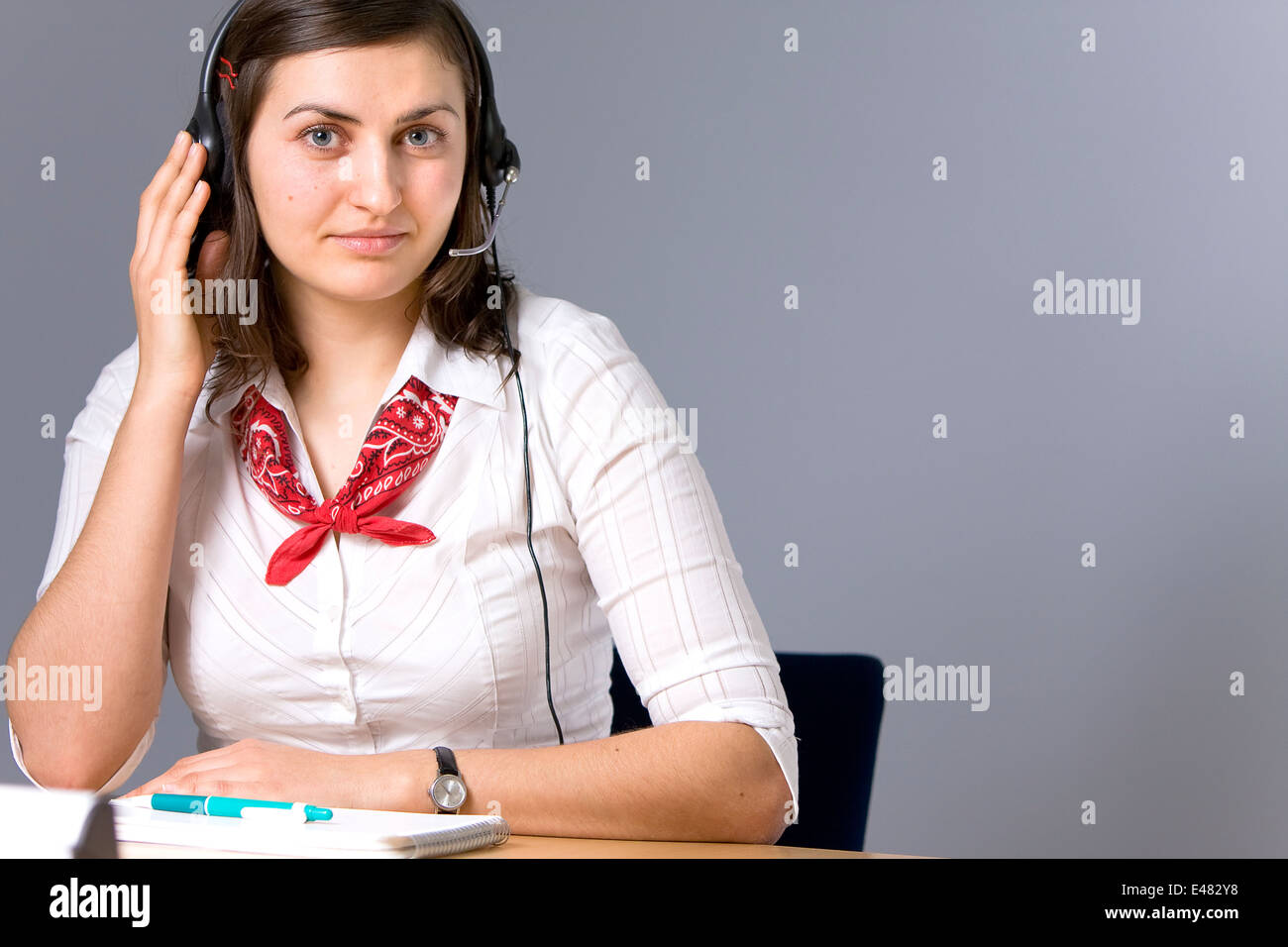 Young beautiful woman with headset laughing while having a telephone ...
