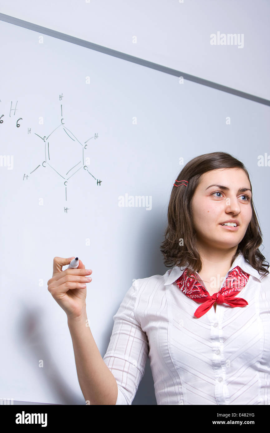 Joyful young chemistry teacher presenting benzene (benzol), an organic ...