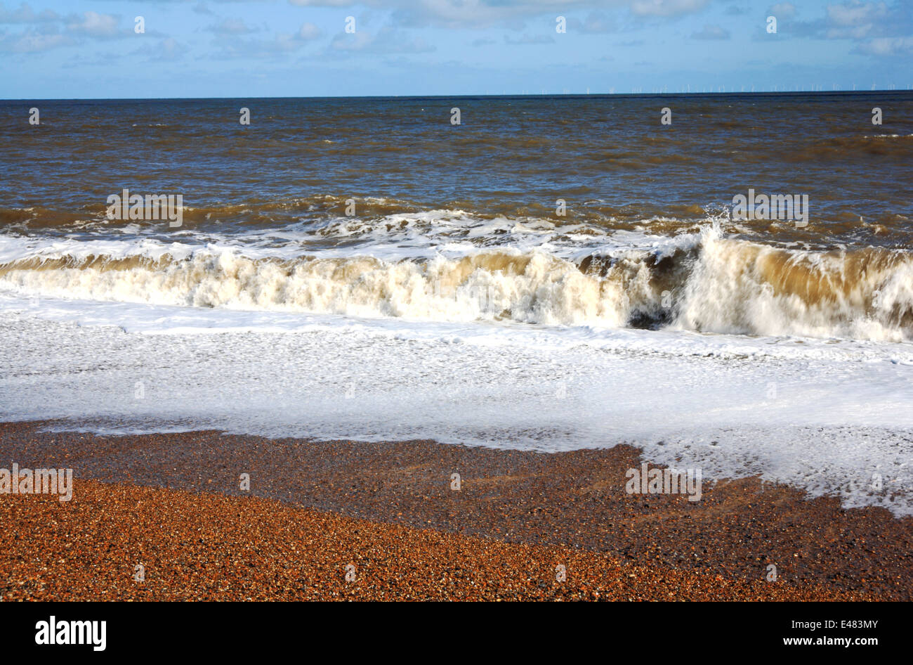 A wave breaking on the beach at Salthouse, Norfolk, England, United ...