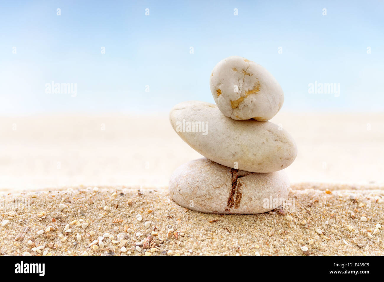 Stack of zen stones on sand beach Stock Photo - Alamy