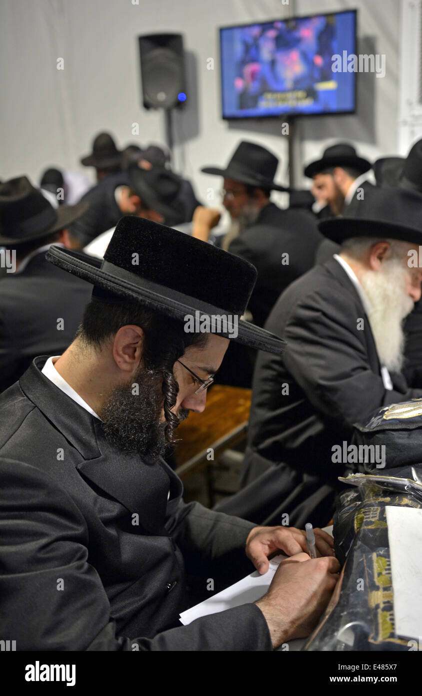 A religious Jewish reading man at morning prayers at the Ohel in ...