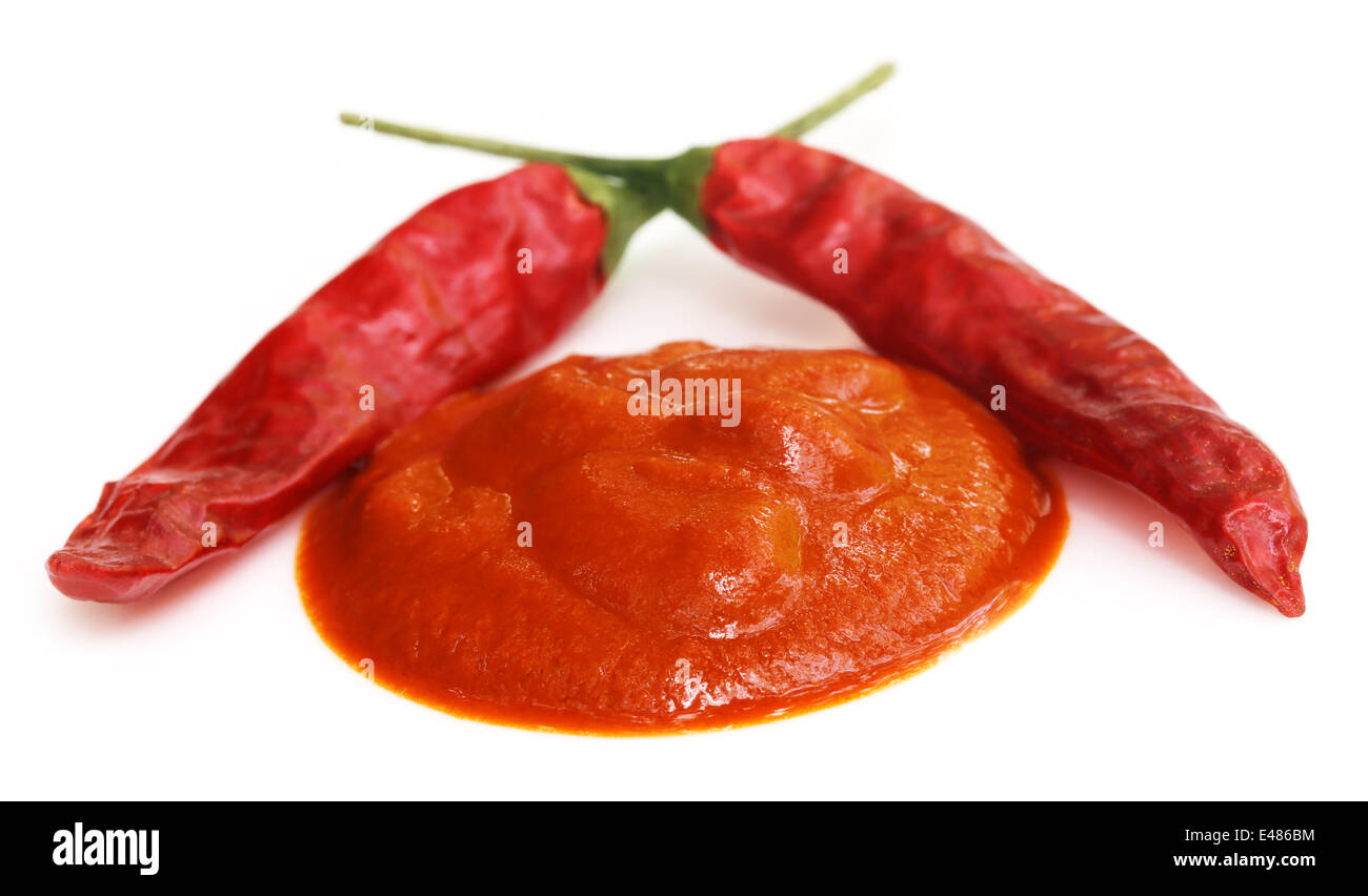Red hot chilies with paste over white background Stock Photo - Alamy