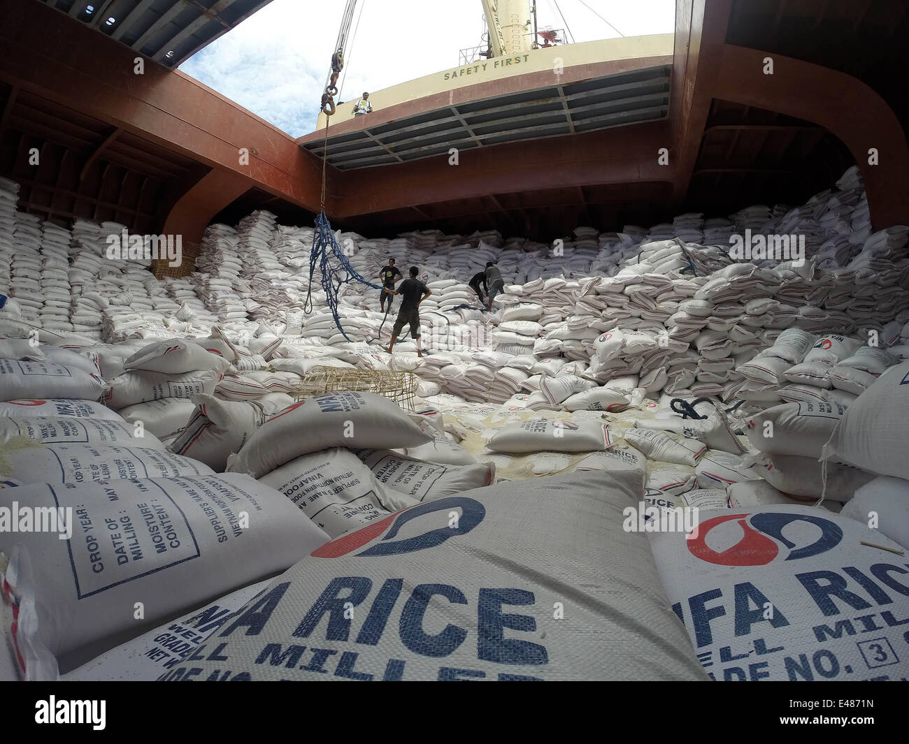 (140705) -- MANILA, July 5, 2014 (Xinhua) -- Workers unload sacks of ...