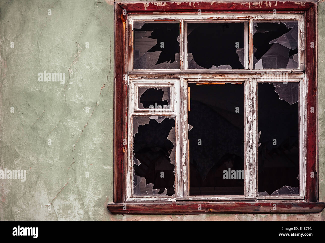Smashed glass Window with old wooden frame on grunge wall damaged house ...
