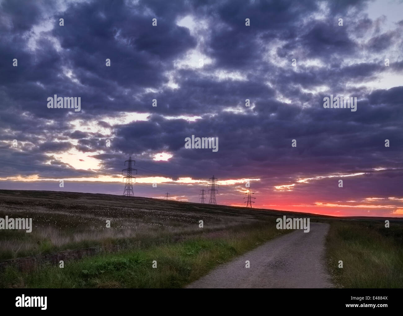 Sunset on the moors with pylons Stock Photo - Alamy