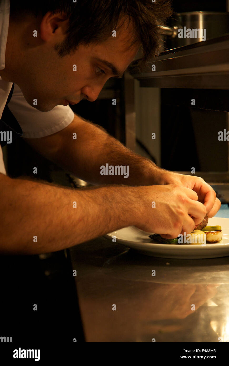 Chef plating up a steak at the "pass Stock Photo - Alamy