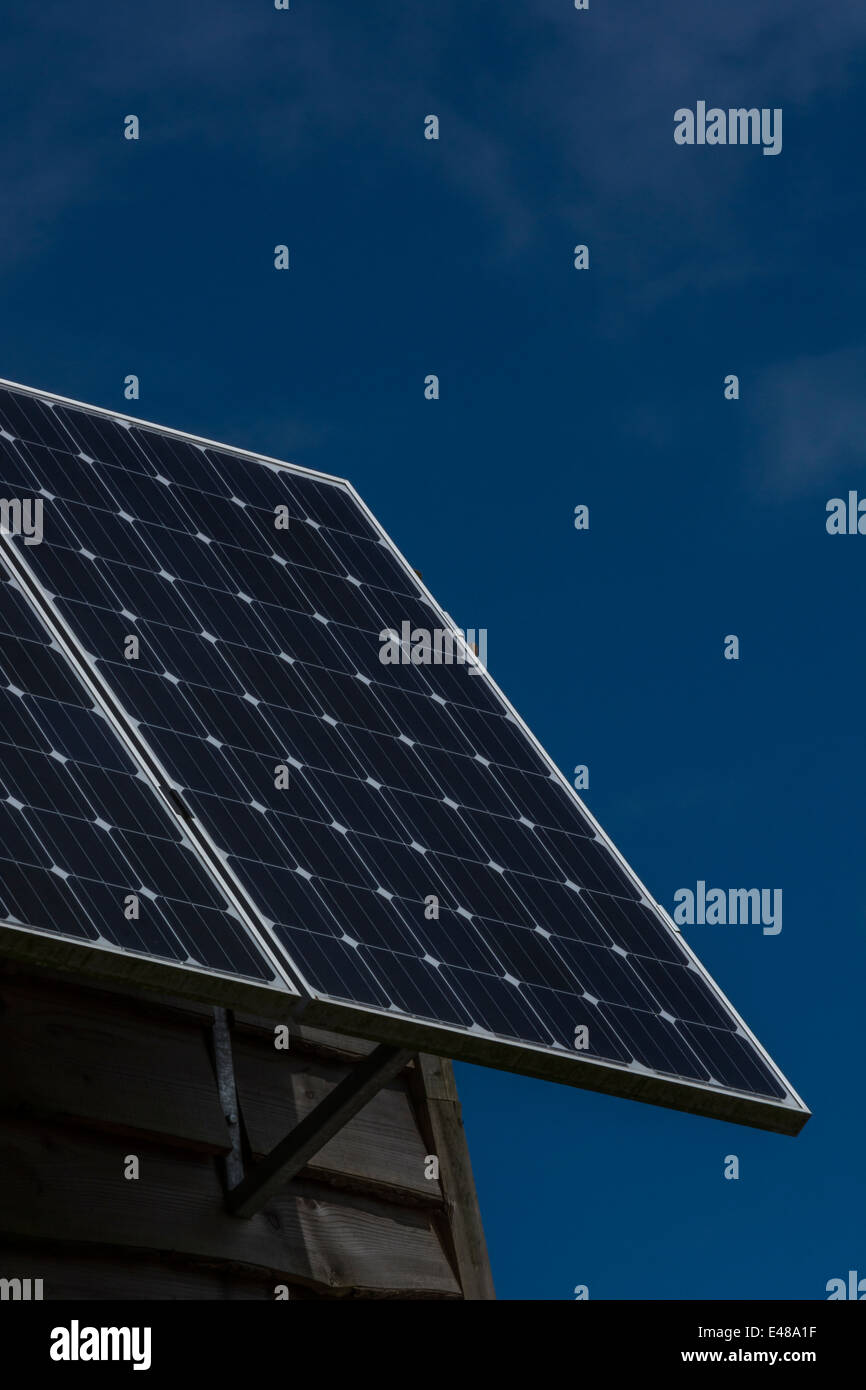 Section of a PVC / Photo-voltaic solar panel against blue summer sky ...