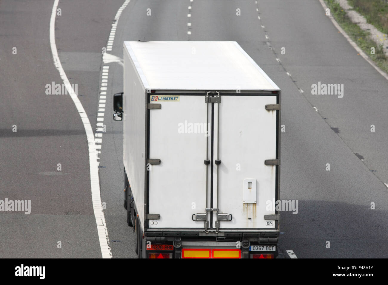 Rear view of an unmarked foreign truck traveling along the M20 motorway ...
