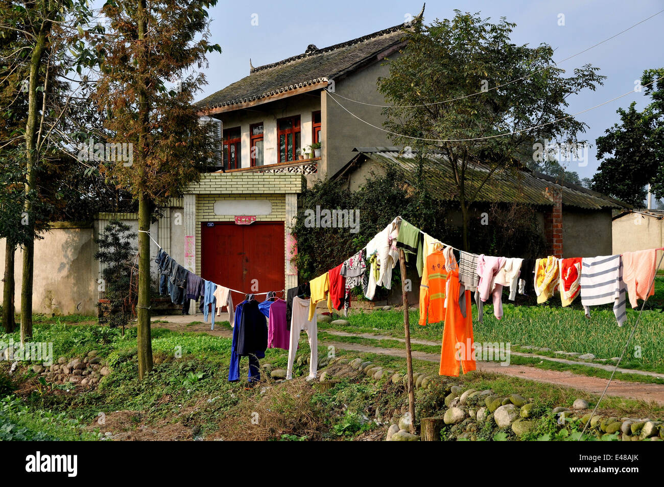 PENGZHOU, CHINA: Laundry dries on a clothes line in front of a large ...