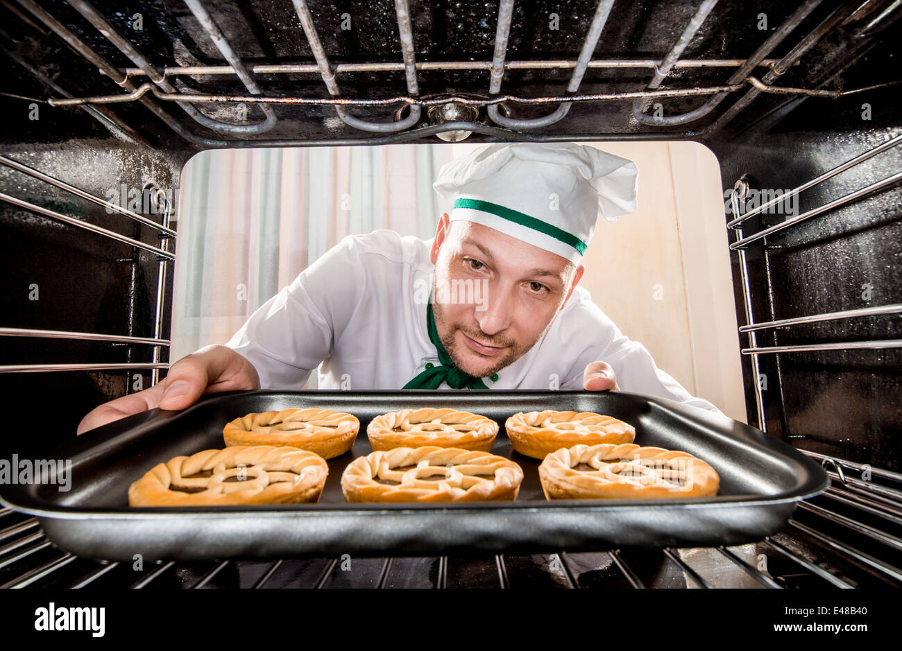 Chef prepares pastries in the oven, view from the inside of the oven ...
