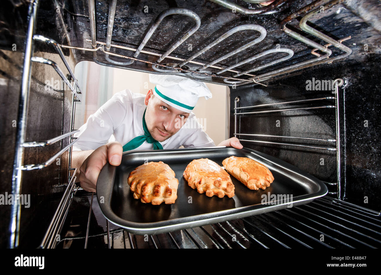 Chef prepares pastries in the oven, view from the inside of the oven ...