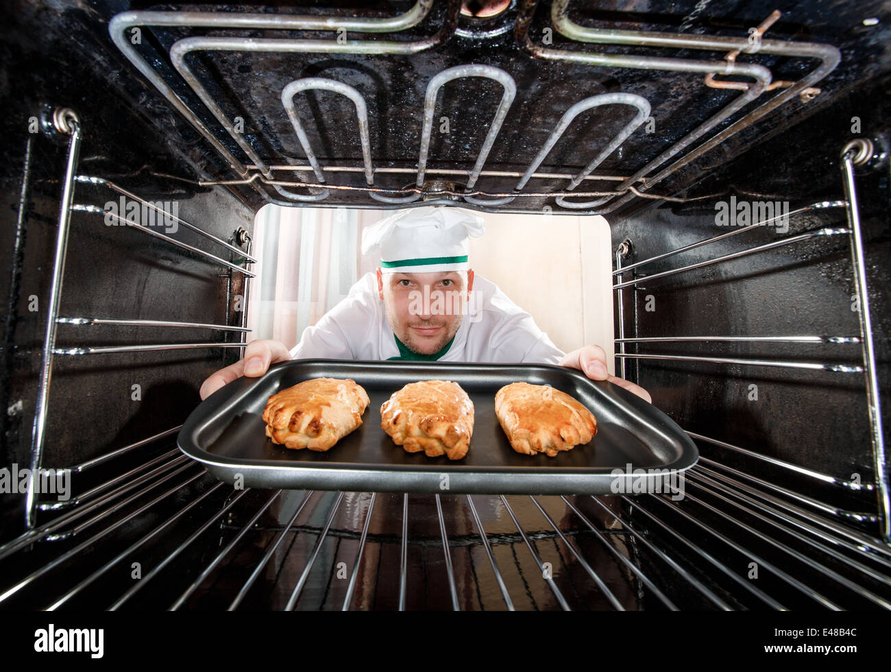 Chef prepares pastries in the oven, view from the inside of the oven ...