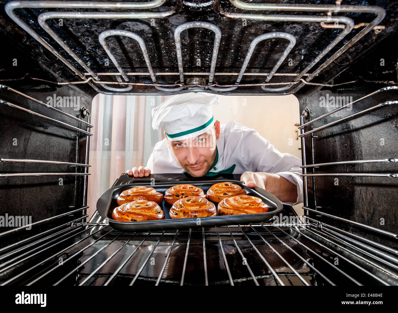 Chef prepares pastries in the oven, view from the inside of the oven ...