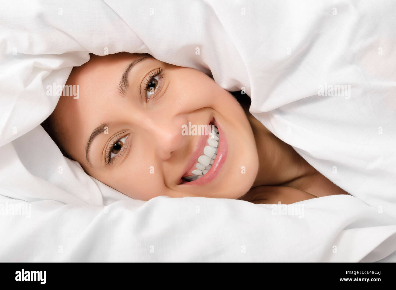 Young woman under duvet hi-res stock photography and images - Alamy