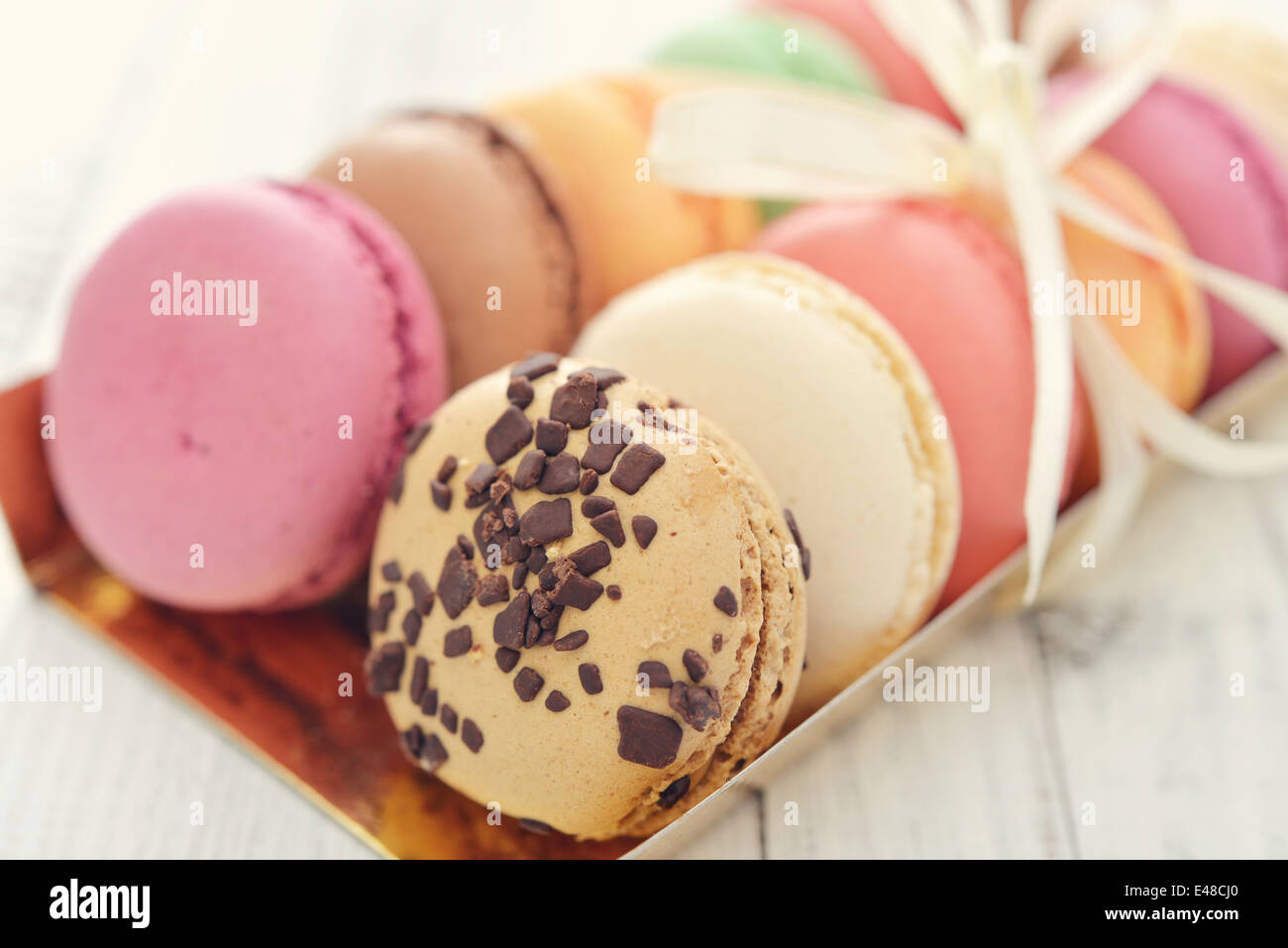 Different kinds of macaroons in stack with ribbon closeup Stock Photo ...