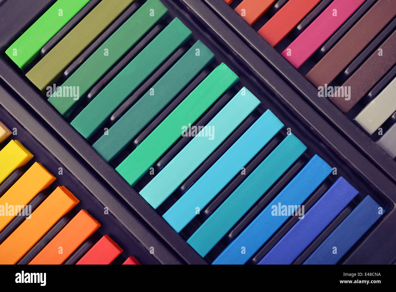 Multicolored artist's pastels in box, top view Stock Photo - Alamy