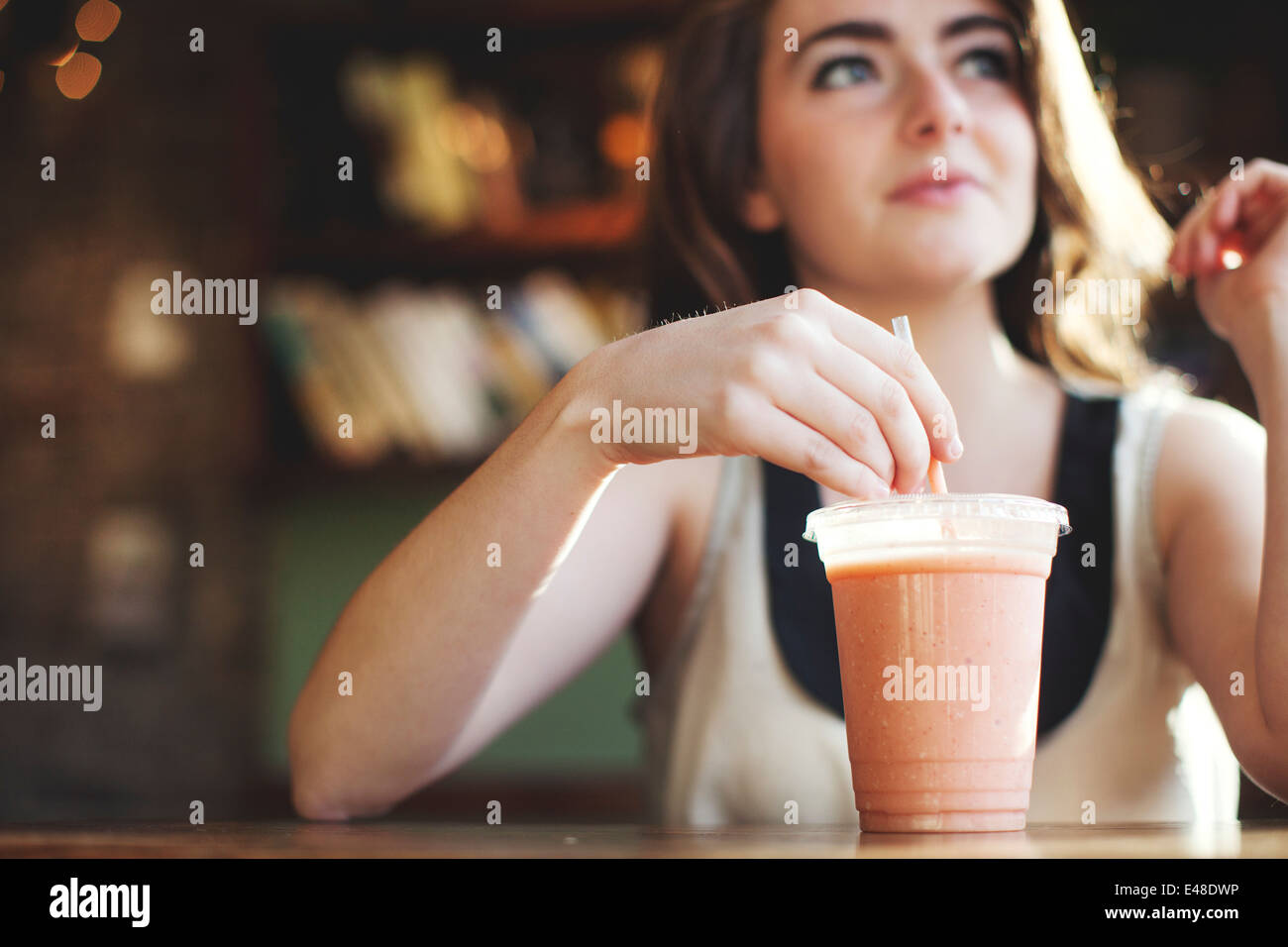 Young woman drinking smoothie Stock Photo - Alamy