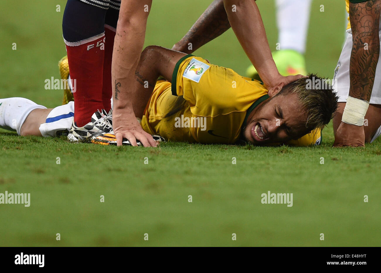 Fortaleza, Brazil. 04th July, 2014. Neymar of Brazil lies on the pitch after picking up an ...
