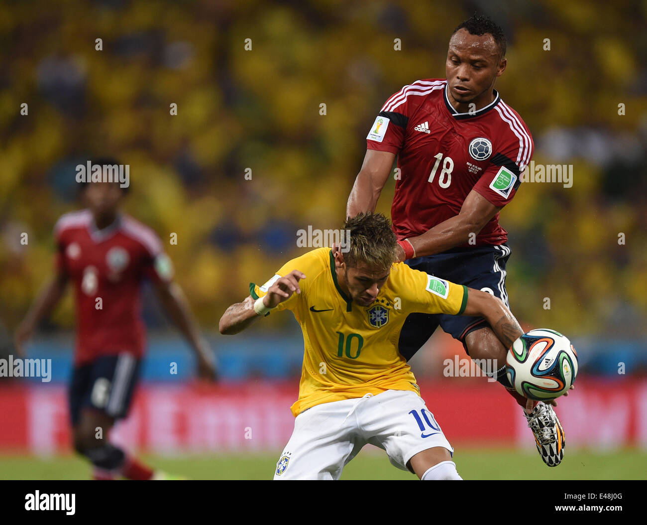Fortaleza, Brazil. 04th July, 2014. Neymar (L) of Brazil takes a heavy tackle in the back from ...