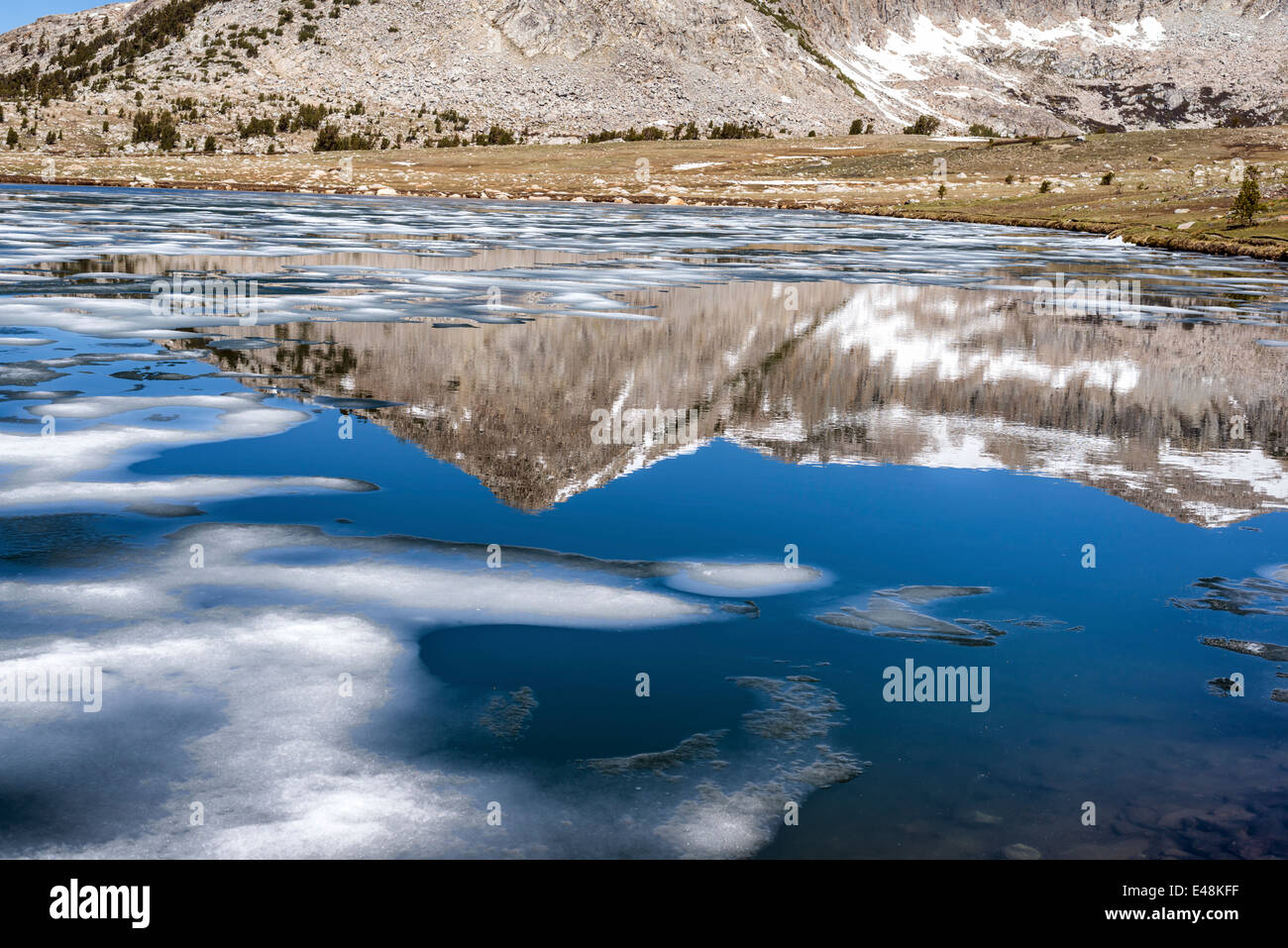 Granite mountain reflecting off of Middle Gaylor Lake.Yosemite National ...