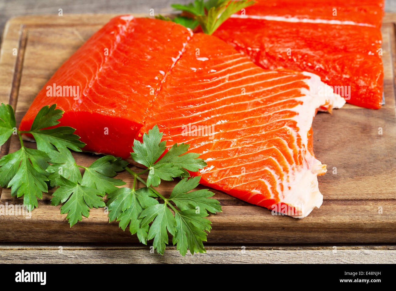 fresh red salmon fillets on traditional wooden server Stock Photo - Alamy