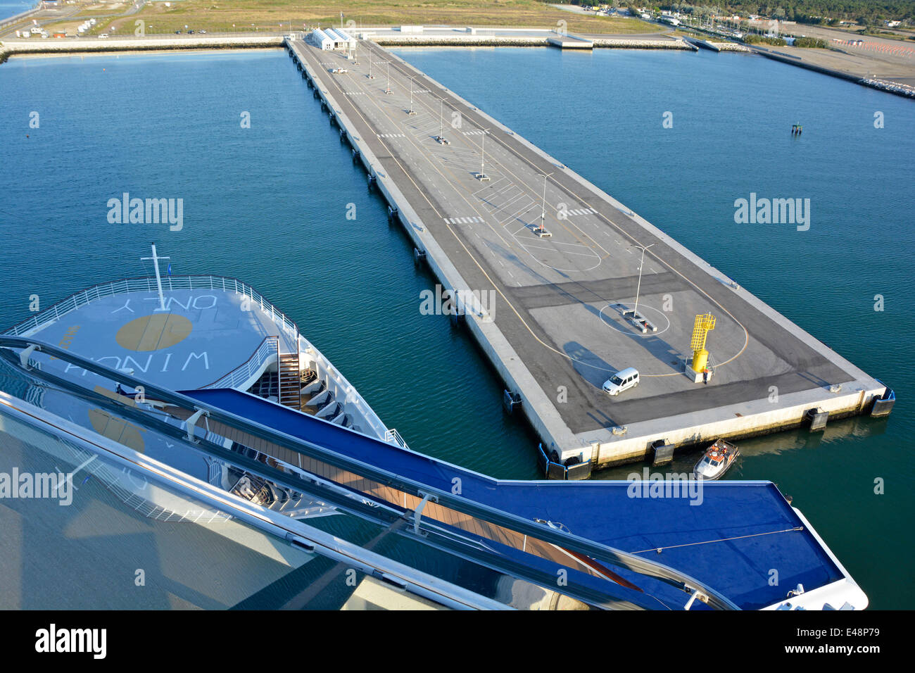 Bow view of large cruise ship slowly approaching jetty at cruise ...