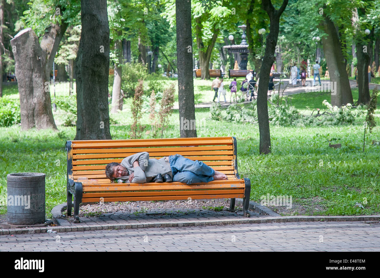 Homelessness person sleeping on bench hi-res stock photography and ...