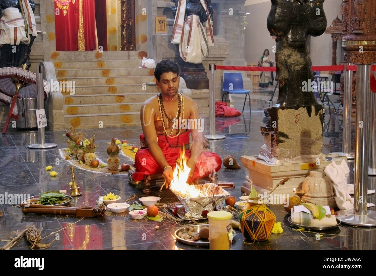 Priests inside a new Hindu temple holding a meditation service Stock ...