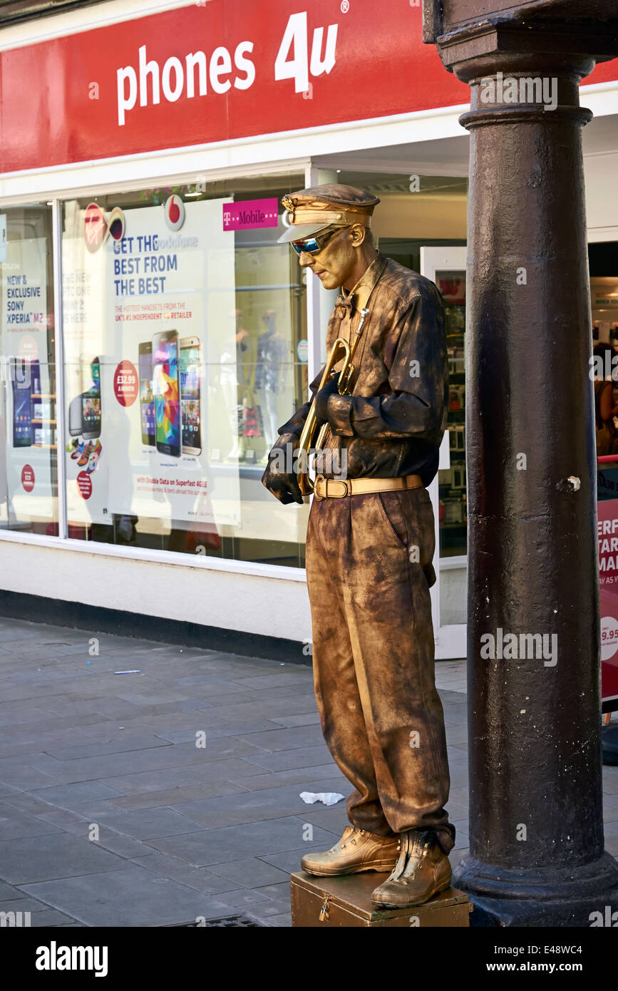 A trumpet playing human statue outside a Phones 4 U shop during ...