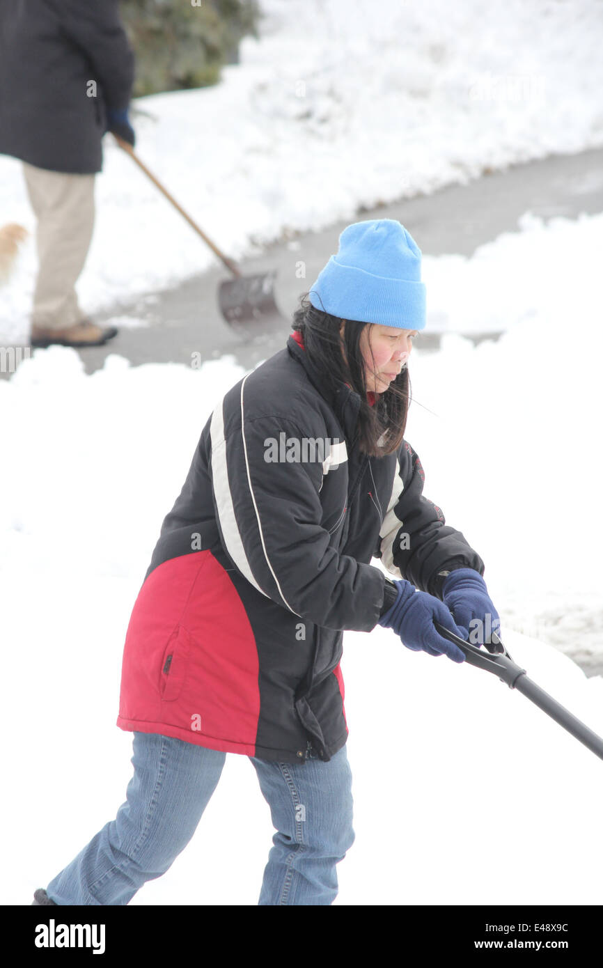 Woman shoveling snow shovel hi-res stock photography and images - Alamy