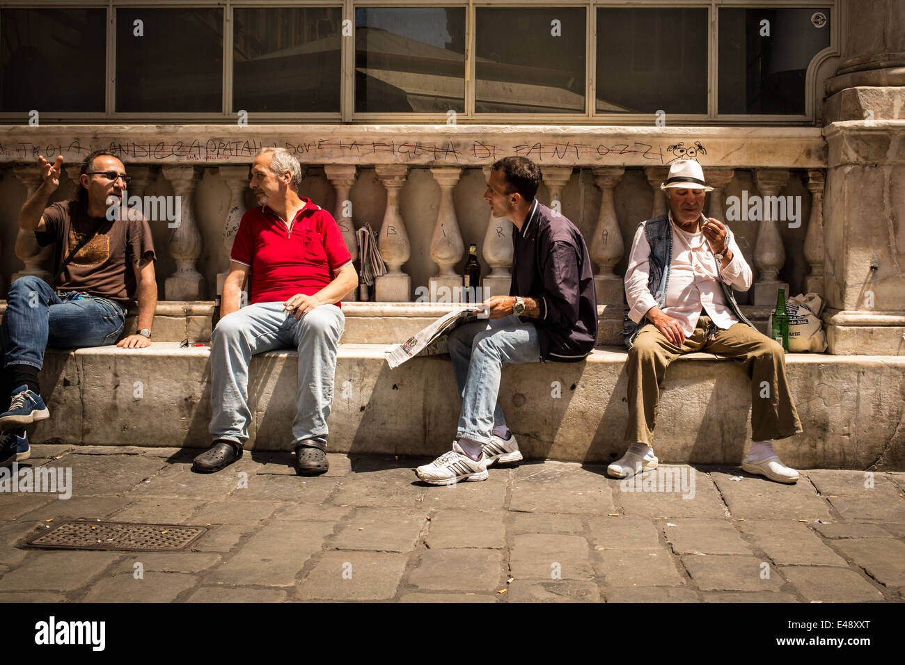 four men seated Stock Photo - Alamy