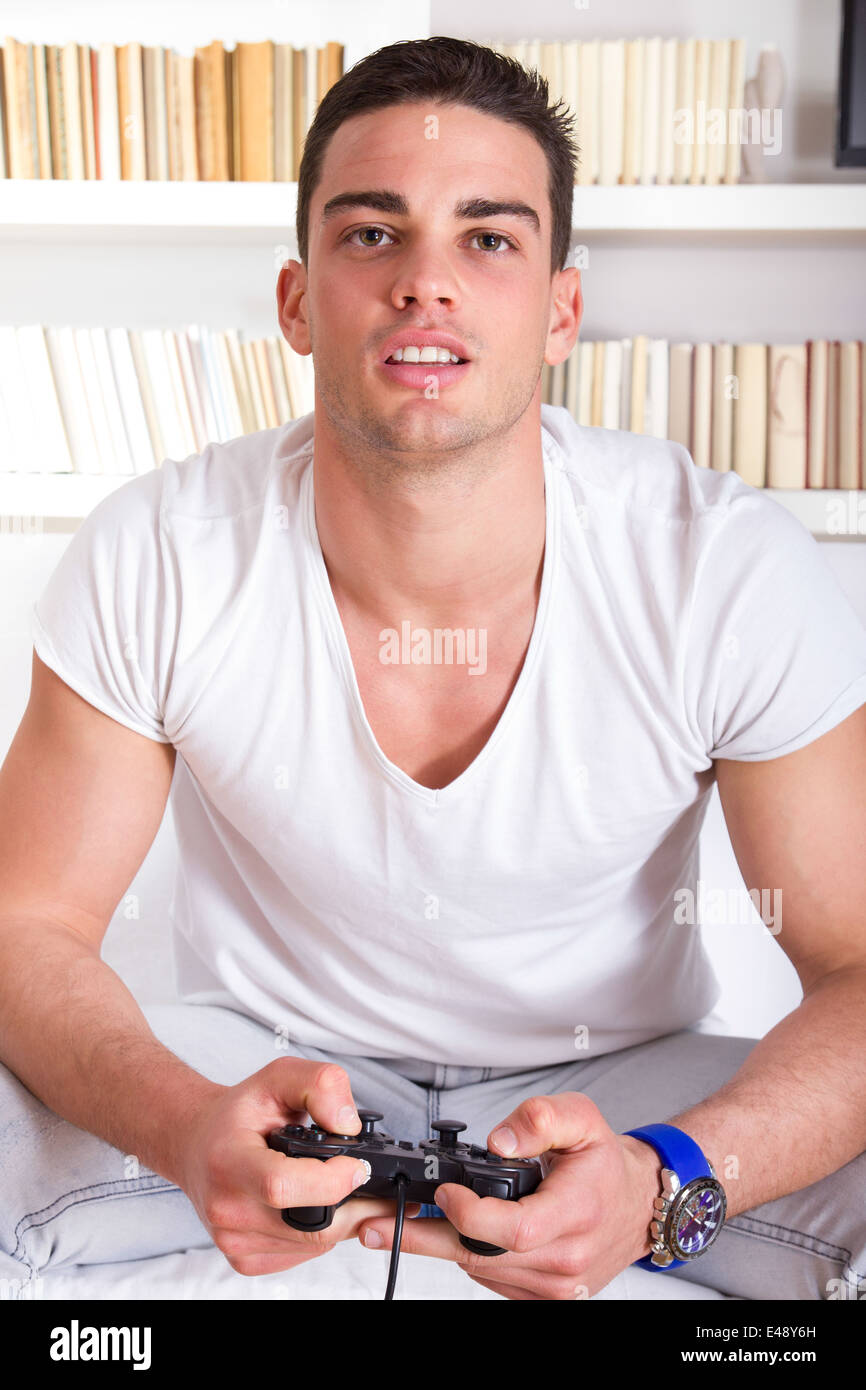 attractive guy concentrating while playing video games at home Stock ...