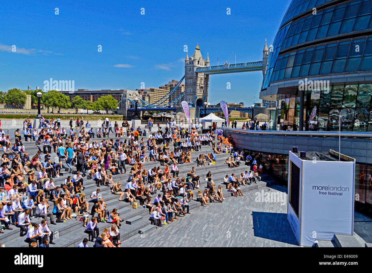 Group of office workers during lunchtime at More London Riverside ...