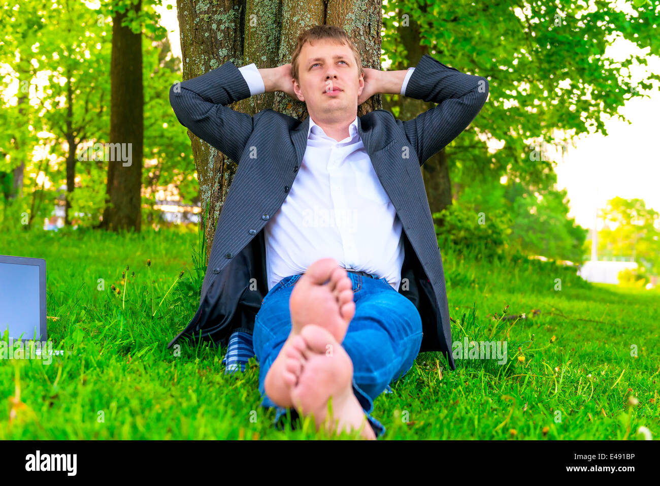 Sitting against tree hi-res stock photography and images - Alamy