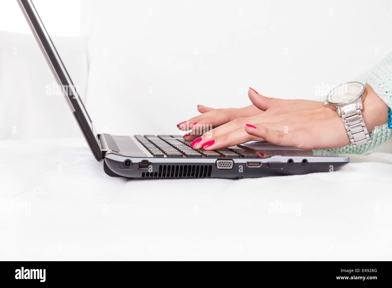 female hands typing on laptop computer keyboard with red nail polish ...