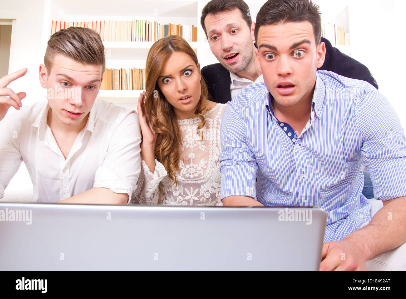 shocked and frustrated casual group of friends sitting on couch looking ...