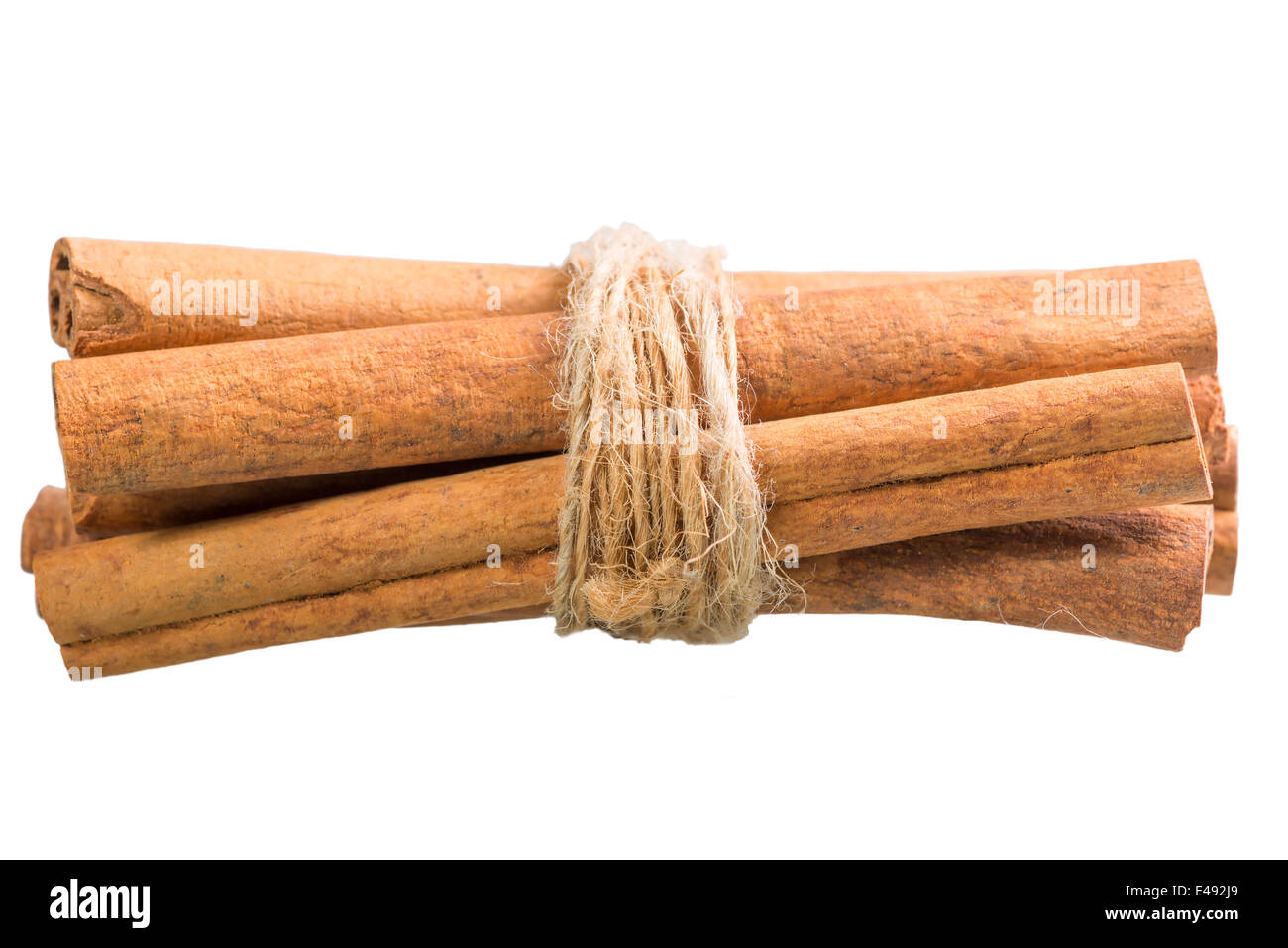 cinnamon sticks tied with a rope on a white background Stock Photo - Alamy