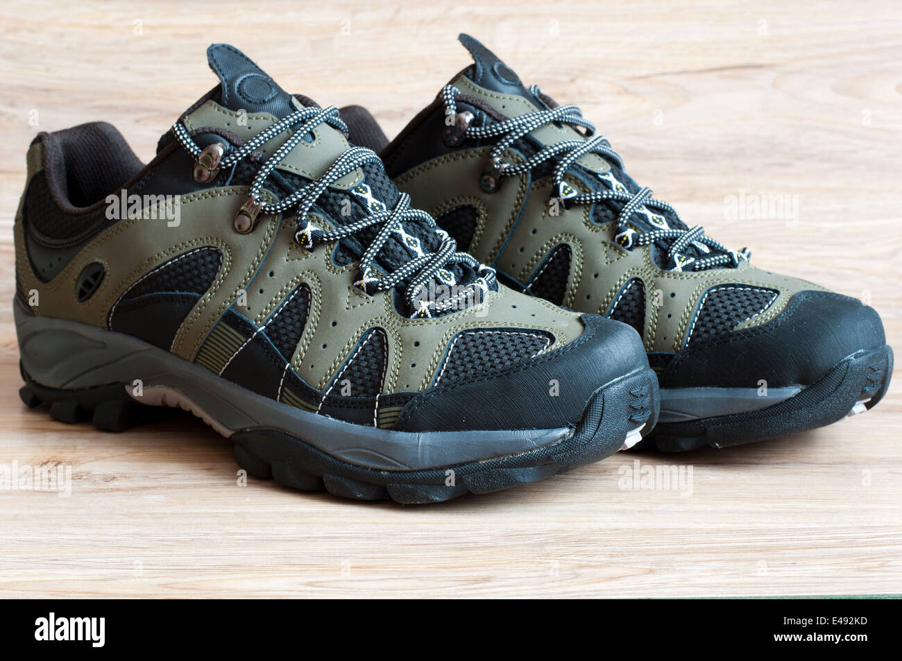 running shoes couple male athletic sideways green black white wooden ...